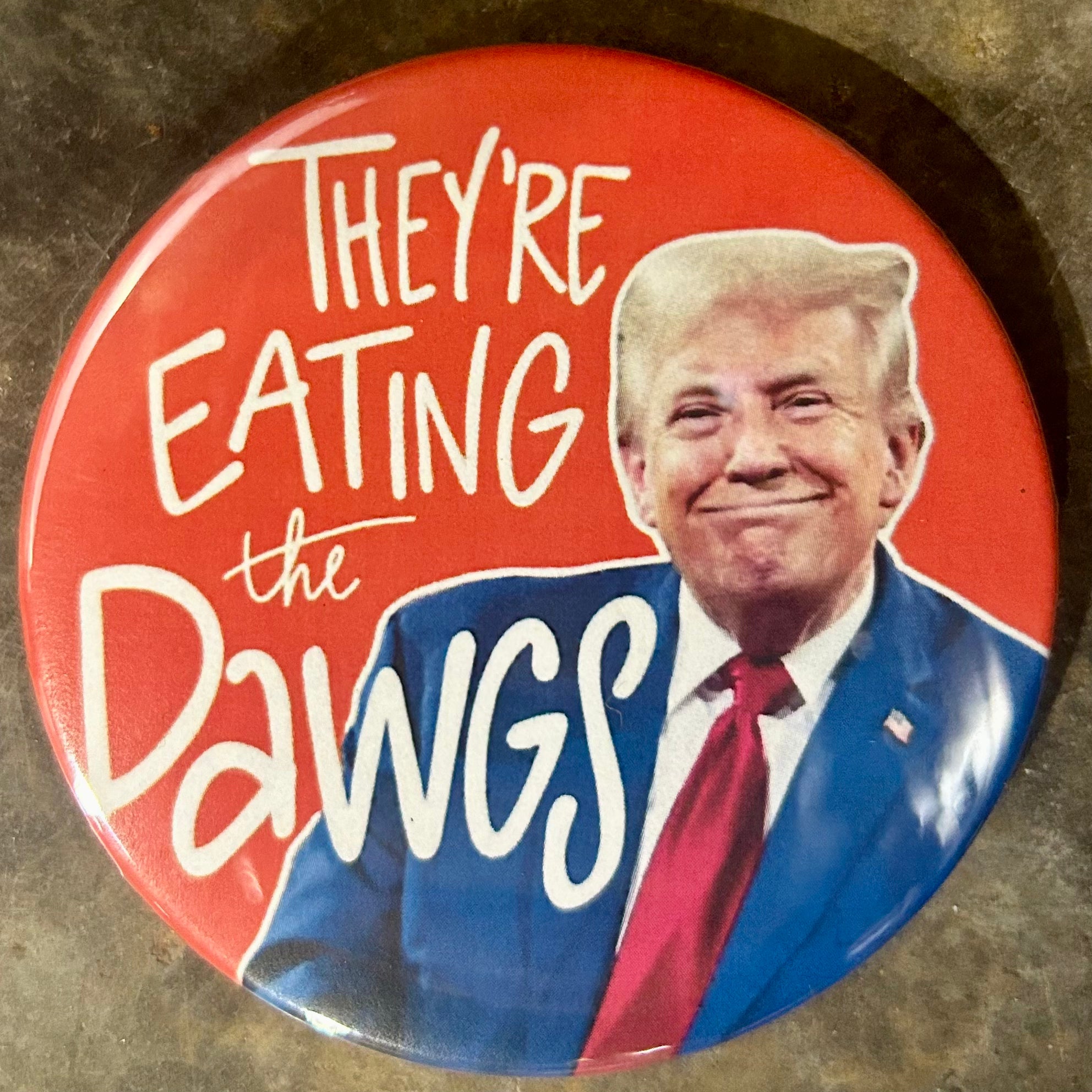 TRUMP THEY’RE EATING THE DAWGS SPIRIT BUTTON – Shop The Greek Freak